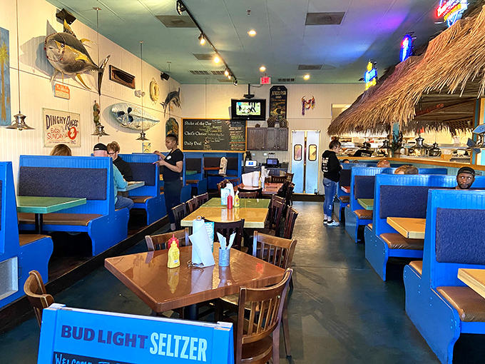 Beach vibes indoors! The bright blue booths and thatched tiki bar create a laid-back atmosphere where calories don't count and conversations flow.