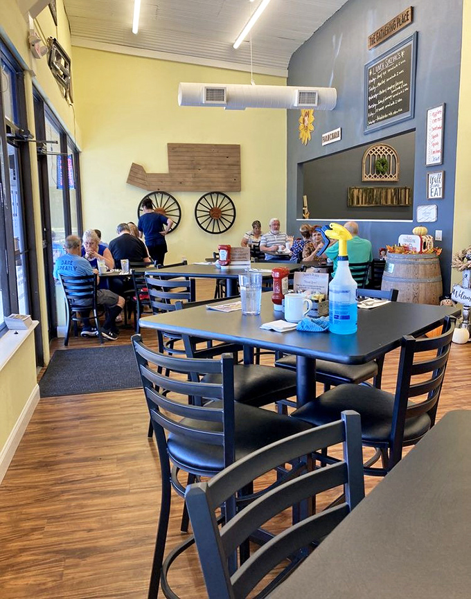 Yellow walls meet blue accents in this cheerful dining space where wagon wheels and wooden accents create that perfect blend of homey and hip.