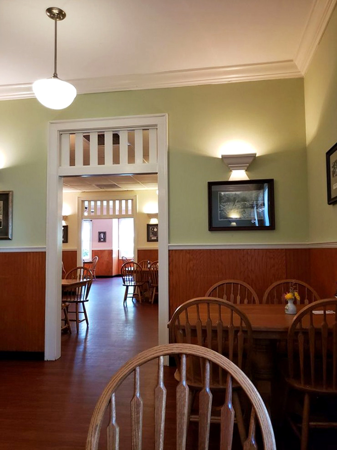 Step inside to a world where sage green walls meet warm wood wainscoting, and Windsor chairs await your increasingly happy bottom. 