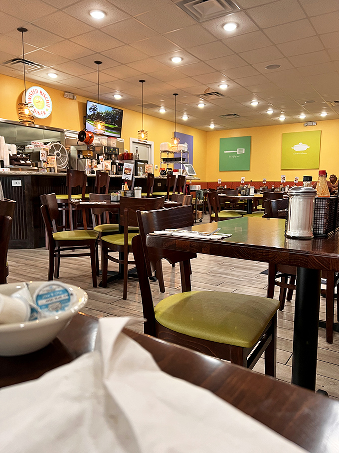 Cheerful yellow walls and wooden tables create the perfect backdrop for biscuit-induced euphoria. This isn't just a diner; it's a morning happiness factory.