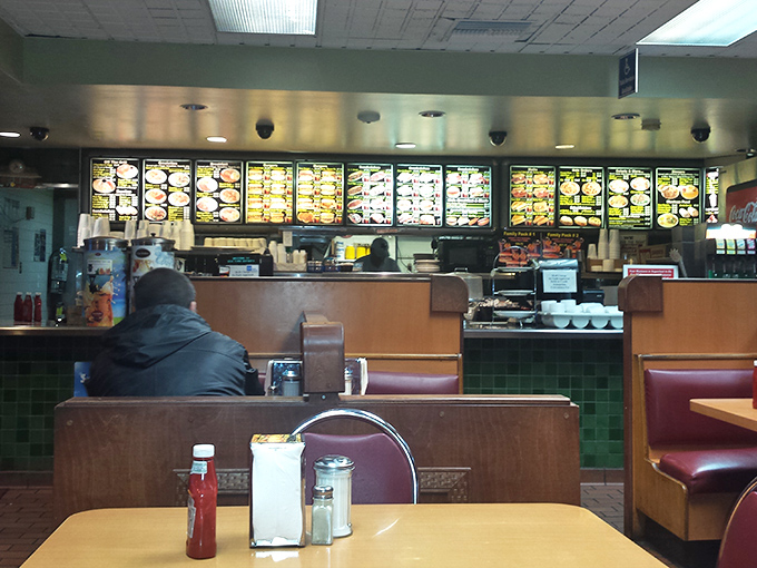 Classic wooden booths and illuminated menu boards create that perfect time-warp feeling&mdash;where decisions about cheese and bacon carry the weight of international diplomacy.