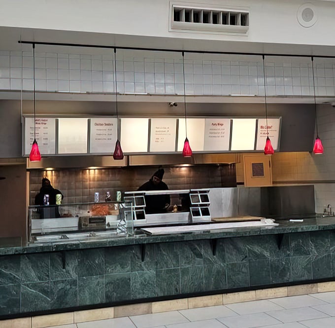 Behind the counter, culinary magic happens. Those red pendant lights aren't just for show&mdash;they're beacons guiding hungry souls to chicken nirvana.