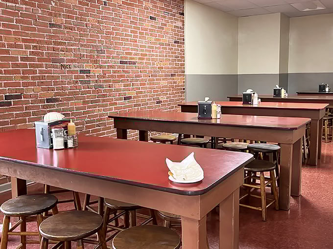 Communal tables with their signature red tops invite strangers to become friends over the shared religion of French dip sandwiches.
