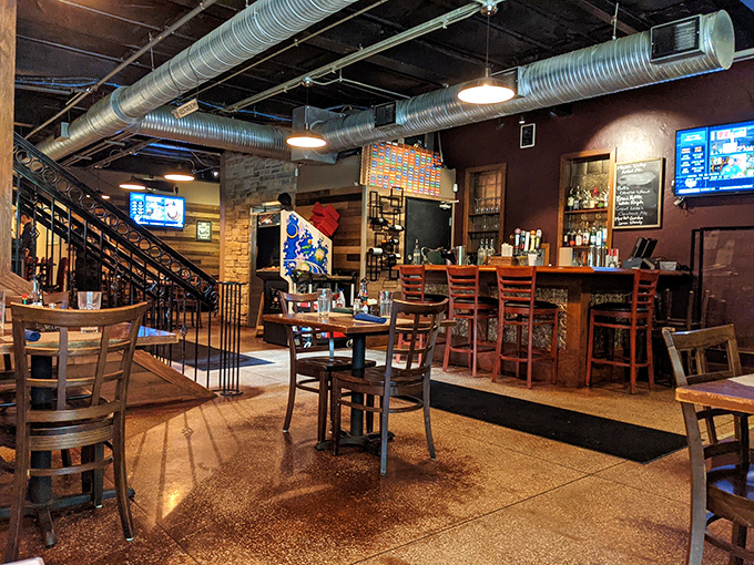 Industrial meets cozy in this thoughtfully designed space where exposed ductwork and brick walls create the perfect backdrop for memorable meals.