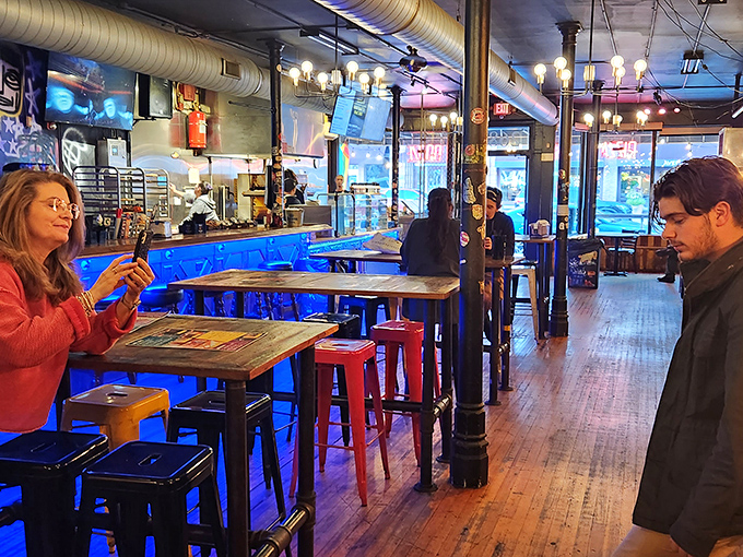 Inside, industrial chic meets pizza paradise with exposed ductwork, wooden floors, and the unmistakable energy of people about to experience pizza nirvana.