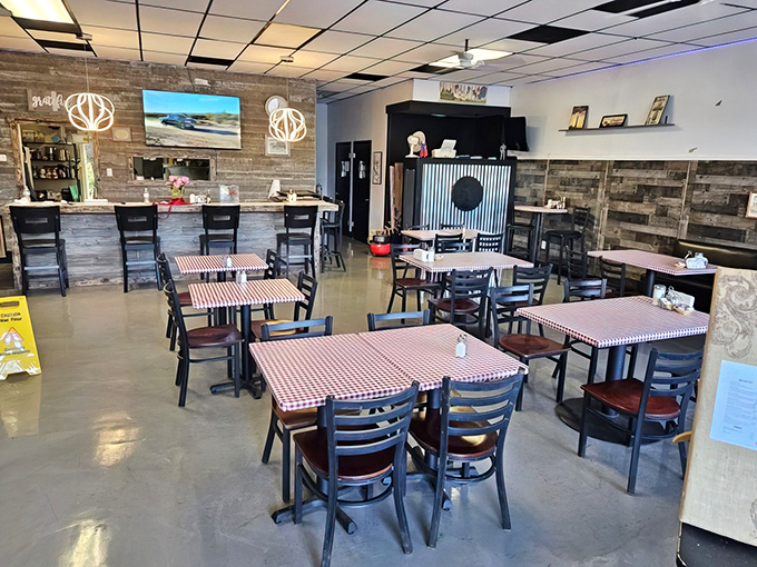 Red and white checkered tablecloths meet rustic wood walls in perfect harmony. This isn't interior design—it's a warm hug disguised as a dining room.