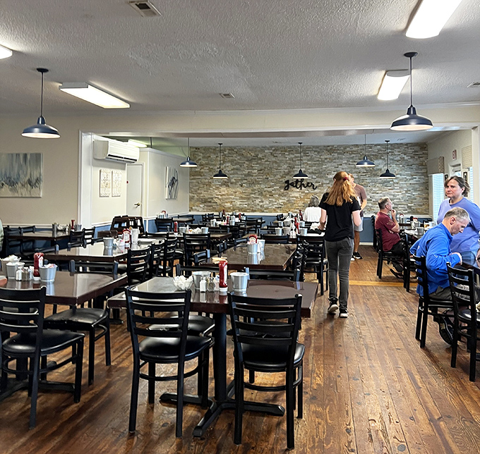 Wooden floors, simple tables, and that stone accent wall create the perfect backdrop for breakfast magic to unfold.