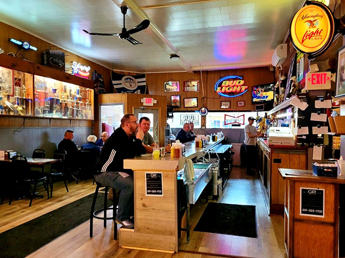 Step inside and you're transported to a simpler time. Wood-paneled walls, neon beer signs, and the promise of comfort food create the perfect small-town tavern atmosphere.