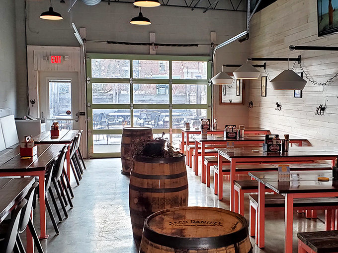 Whiskey barrels meet modern industrial chic inside Pecan Penny's, where the garage door blurs the line between indoor comfort and patio vibes.