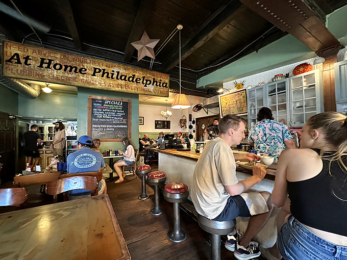 Inside, wooden counters and exposed beams create that perfect "where everybody knows your name" vibe. The "At Home Philadelphia" sign isn't kidding.