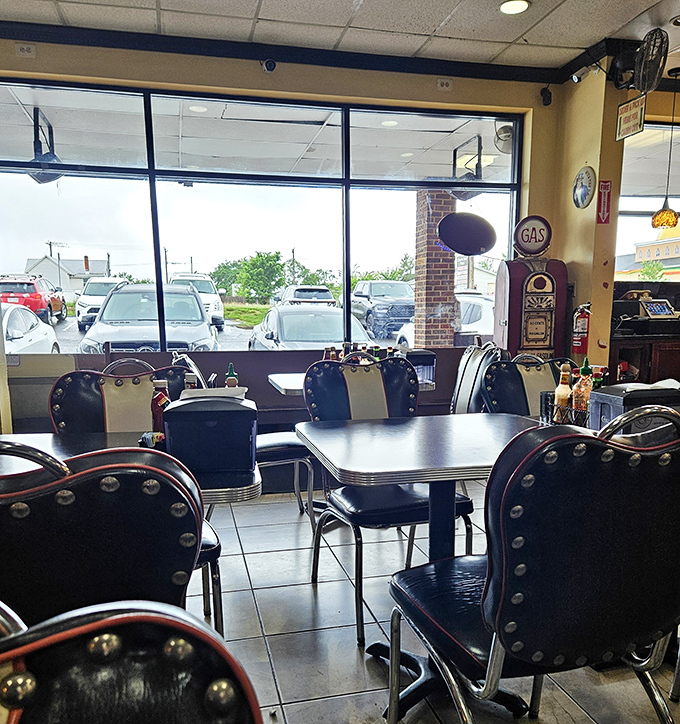 Classic Americana lives in these navy blue vinyl booths with silver studs, where vintage gas pump decor meets the timeless ritual of breaking bread together.