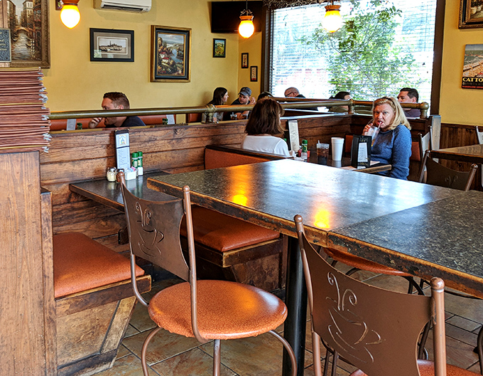 Cozy wooden booths and warm yellow walls transport diners straight to Italy. The dining room's intimate atmosphere makes every meal feel like a special occasion.