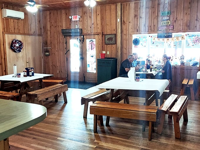 Knotty pine walls and picnic tables create the perfect rustic backdrop for the serious business of barbecue consumption.