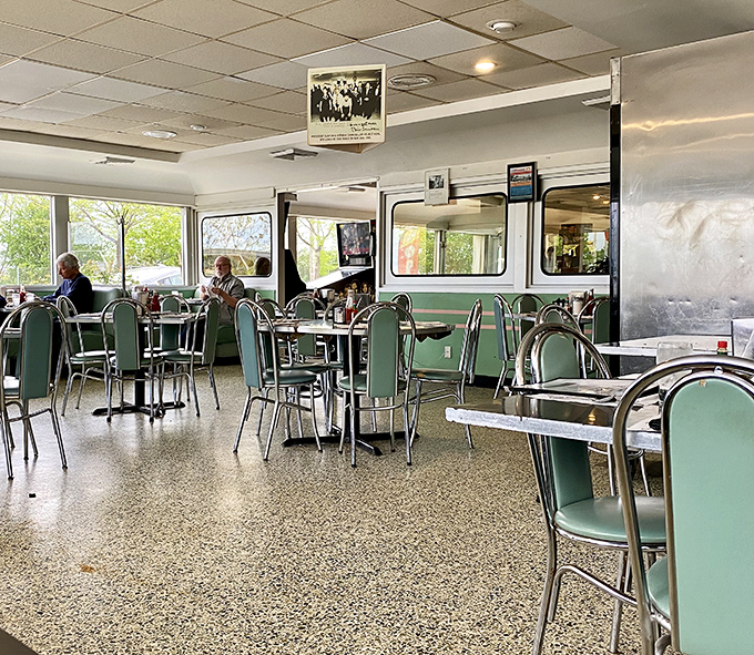 Mint green vinyl chairs and classic chrome tables create that perfect 1950s atmosphere where conversations flow as freely as the coffee.