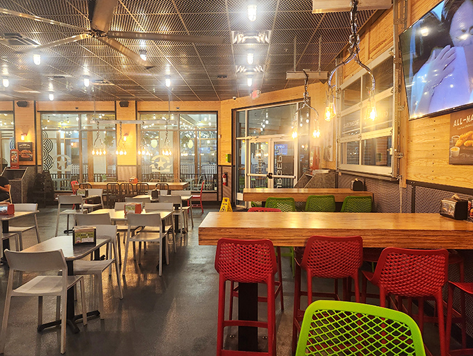 Industrial-chic meets comfort in BurgerFi's interior, where colorful chairs pop against wooden tables. It's like your cool friend's loft, but with better food. 