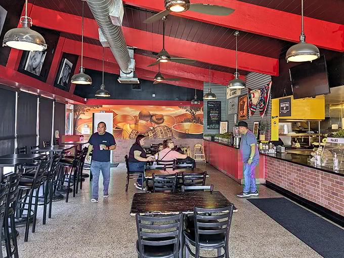 Red ceiling beams frame a cozy dining space where carnitas dreams come true. Simple tables, big flavors&mdash;exactly as it should be.