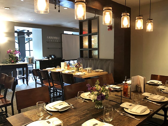 Inside, rustic wooden tables meet modern lighting fixtures, creating that rare atmosphere where fine dining feels like coming home.