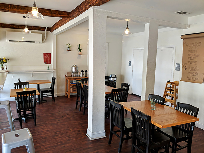 Rustic wooden beams meet clean white walls in this cozy sanctuary where carb-counting goes to die. The minimalist design lets the baked masterpieces take center stage.