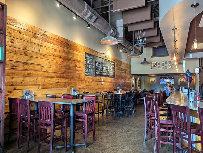 Rustic meets industrial in this warm, inviting space where reclaimed wood walls and pendant lighting create the perfect backdrop for memorable meals.