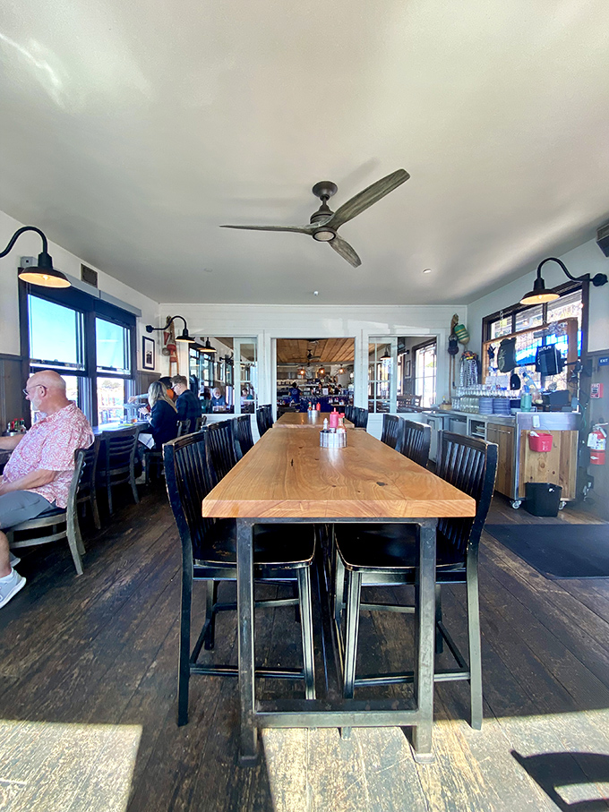 The communal table isn't just furniture&mdash;it's where strangers become friends over shared plates and the universal language of "pass the butter."