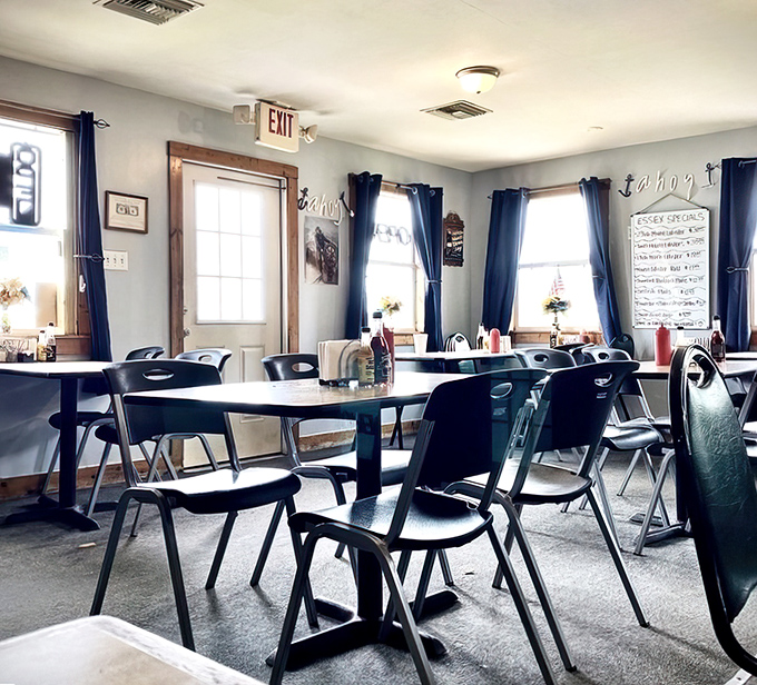Simple tables, navy curtains, and nautical touches create the perfect backdrop for seafood stardom &ndash; no white tablecloths needed when the food's this good.