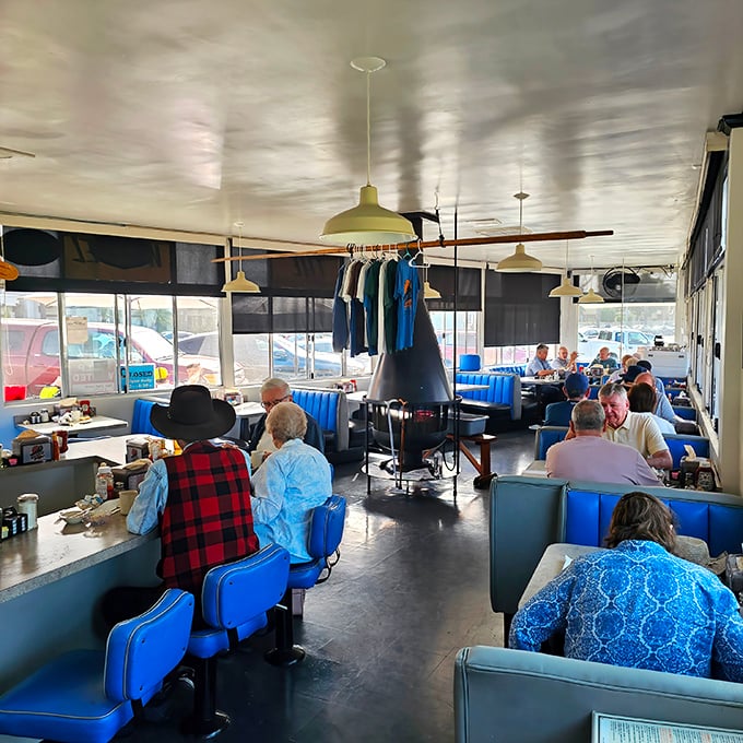 Blue vinyl booths and counter seating create the perfect backdrop for morning conversations and coffee refills that never seem to end.