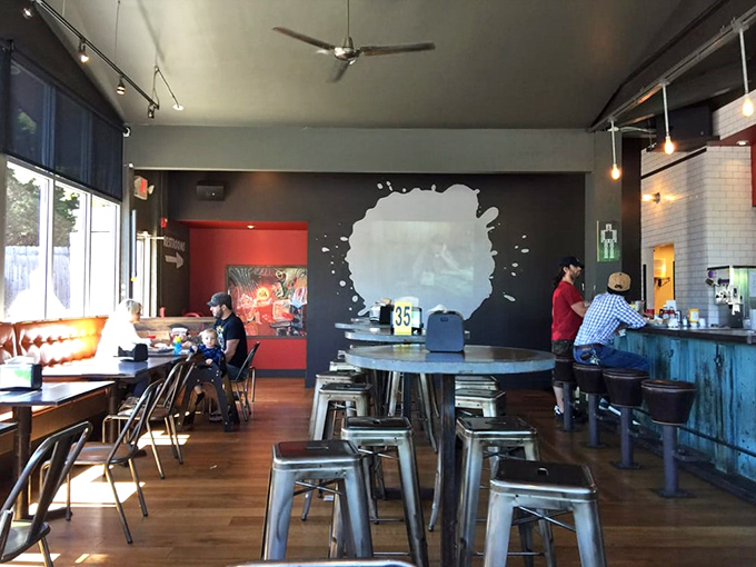 Industrial-chic meets burger paradise inside, where metal stools and splatter-paint walls create the perfect backdrop for your impending food euphoria.