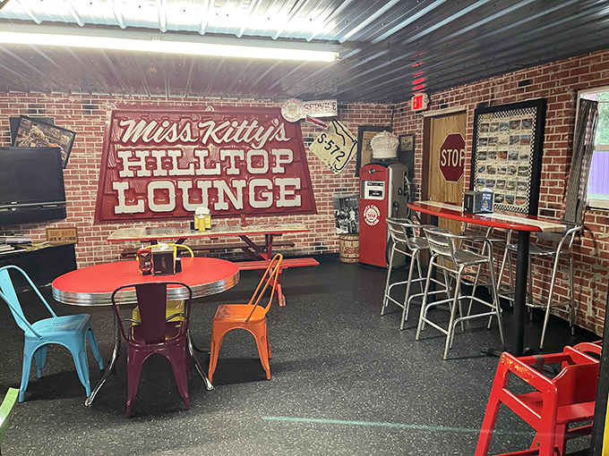 Miss Kitty's Hilltop Lounge offers a colorful retreat with its brick walls, vintage signs, and those impossibly cheerful metal chairs that somehow make everything taste better.