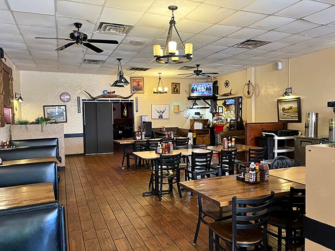 Simple wooden tables, Texas memorabilia, and ceiling fans spinning lazily overhead&mdash;this isn't designer ambiance, it's authentic steak house atmosphere at its finest.