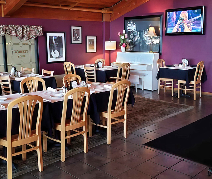 Purple walls, a white piano, and wooden beams create an atmosphere where Frank Sinatra would feel right at home—possibly ordering a second helping of everything.
