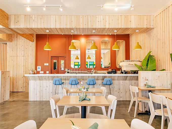 Light wood meets terracotta warmth in this Instagram-ready interior. Those yellow pendant lights could make even morning grumps smile.