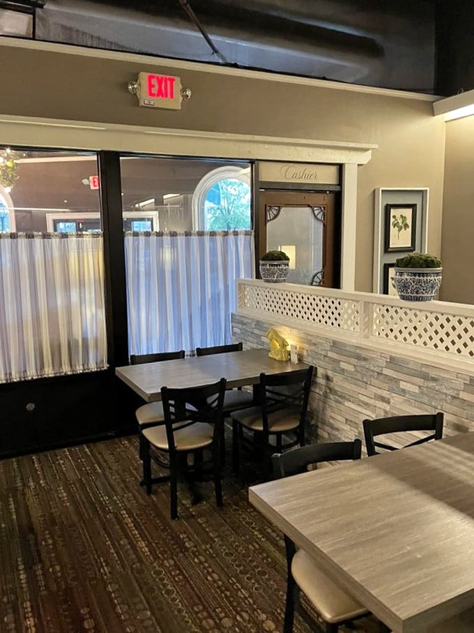 Elegant simplicity defines the dining area, where lattice dividers and clean lines create intimate spaces for savoring comfort food without distraction.