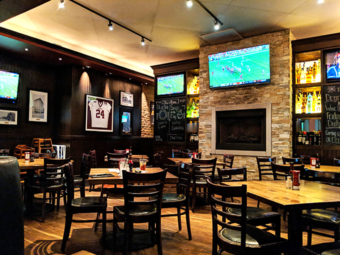 Inside, the warm wood tones, stone fireplace, and strategically placed TVs create that rare sports bar where you can actually have a conversation without shouting.