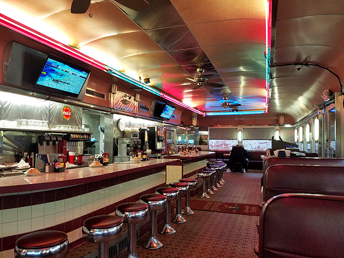 Step inside where neon dreams and vinyl booths create the perfect backdrop for serious comfort food conversations.