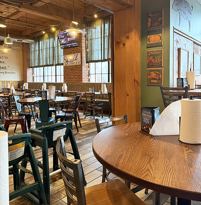 Wooden tables, exposed brick, and natural light create the perfect backdrop for the smoky drama about to unfold on your plate.