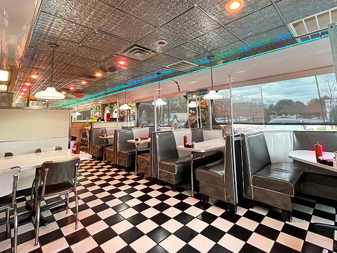 Classic black and white checkered floors meet silver-flecked ceiling tiles, creating that perfect diner atmosphere where calories don't count and conversations flow freely.