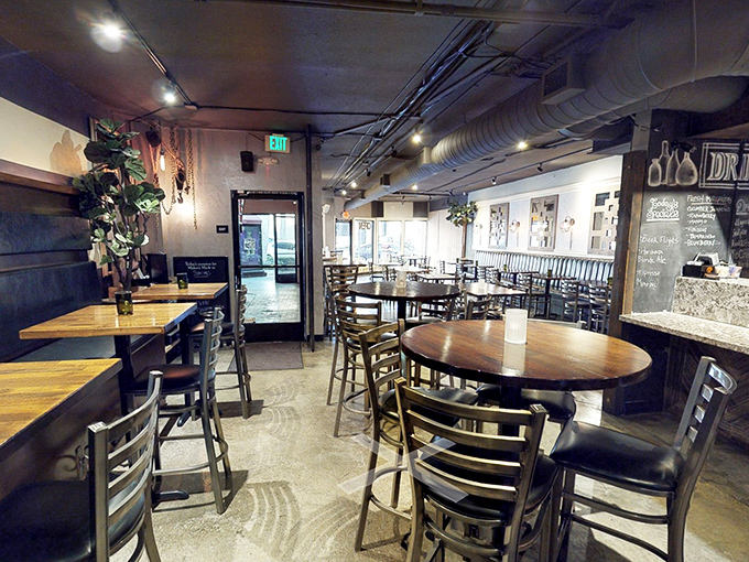 Industrial meets comfort in this thoughtfully designed interior. The exposed ductwork and wooden tables say, "We're serious about our BBQ, not our decorating budget."