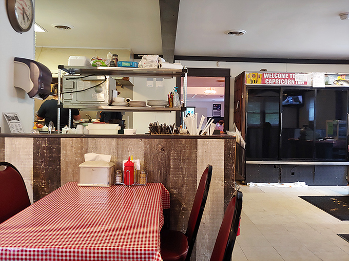 Classic red-and-white checkered tablecloths set the stage for comfort food theater, where every meal feels like a homecoming.