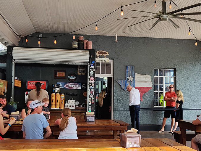 Where Texas meets Florida&mdash;rustic wooden tables, string lights, and that Texas-shaped wall art remind you this is serious barbecue territory.