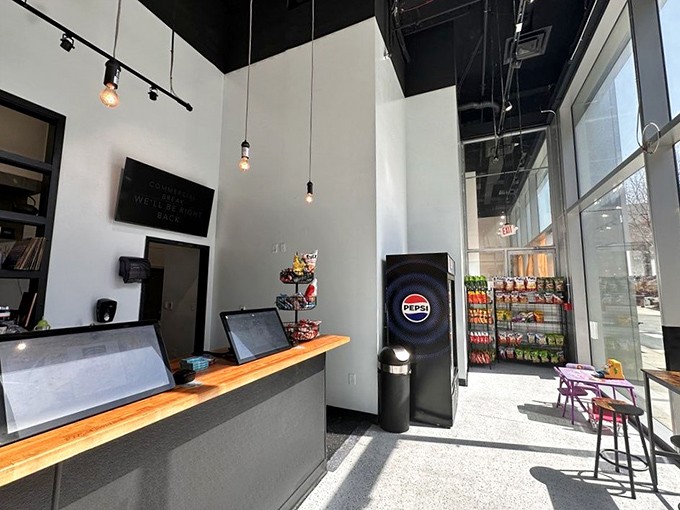 Edison bulbs dangle from the black ceiling, casting a warm glow over the minimalist counter where sandwich magic happens daily.
