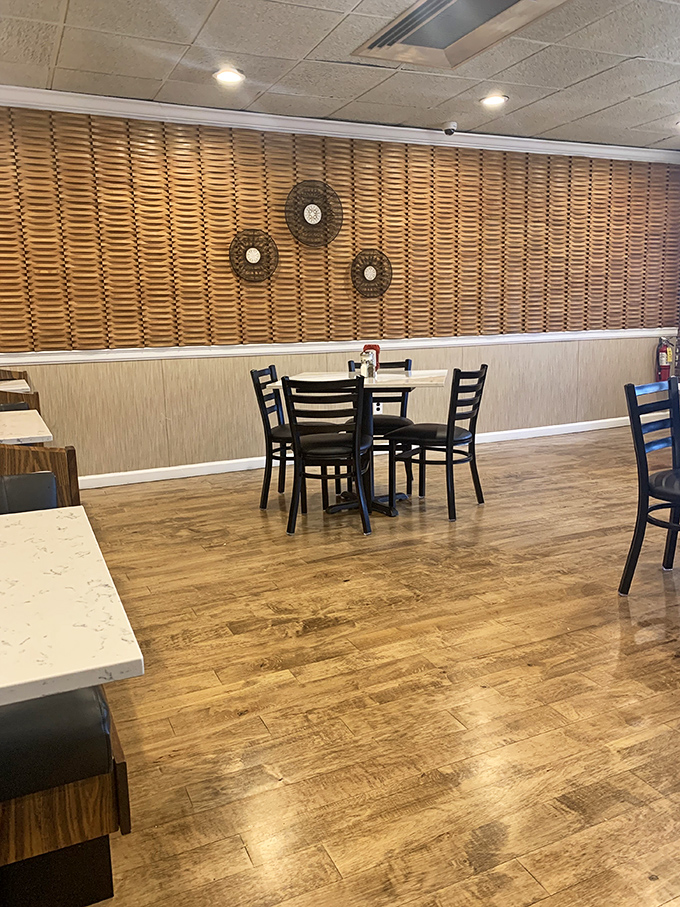 Simple elegance defines this dining space where wooden accents and comfortable seating invite you to settle in for a meal worth savoring.