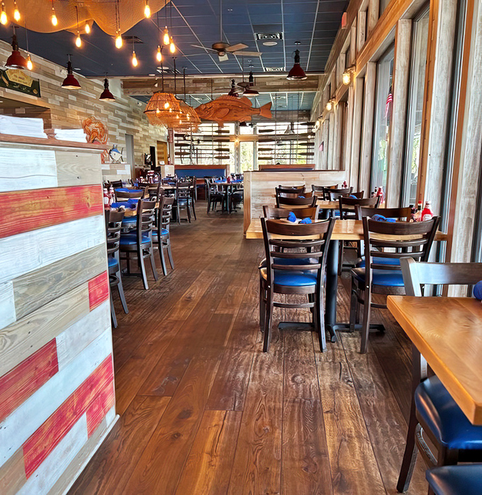 Warm wooden interiors, nautical-inspired pendant lights, and floor-to-ceiling windows create the perfect backdrop for seafood indulgence.