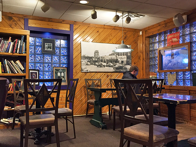 Wood-paneled walls and blue glass blocks create a cozy time capsule where coffee meets nostalgia.