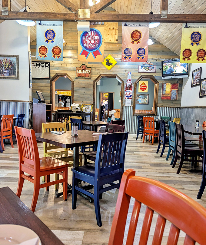 Colorful chairs pop against wooden beams and award banners, creating that perfect "come as you are, leave fuller" dining atmosphere.