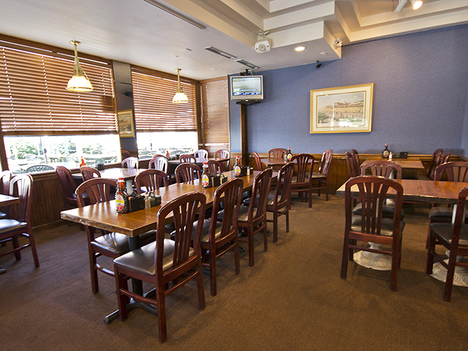 Wooden chairs and blue walls create the perfect backdrop for morning conversations and maple syrup decisions.