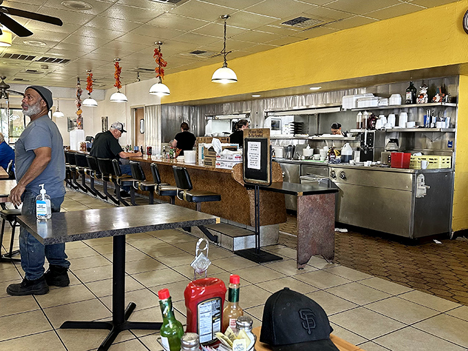 Where breakfast dreams come true: The open kitchen design lets you witness the morning magic happen while counter seats offer front-row views to the culinary choreography.