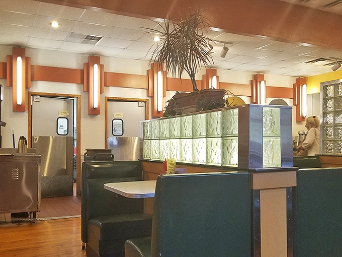 Classic diner aesthetics meet cozy comfort with glass block dividers and warm lighting. This isn't Instagram-bait design&mdash;it's the real deal where conversations flow as freely as the coffee. 