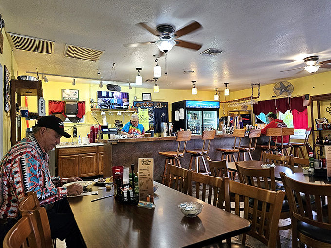 Inside, the cozy yellow walls and wooden furnishings create that perfect small-town diner atmosphere where conversations flow as freely as the coffee.