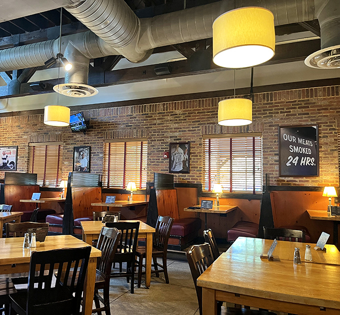 Industrial chic meets Southern comfort in this dining room where exposed ductwork and brick walls frame the real artwork: plates of perfectly smoked meat.
