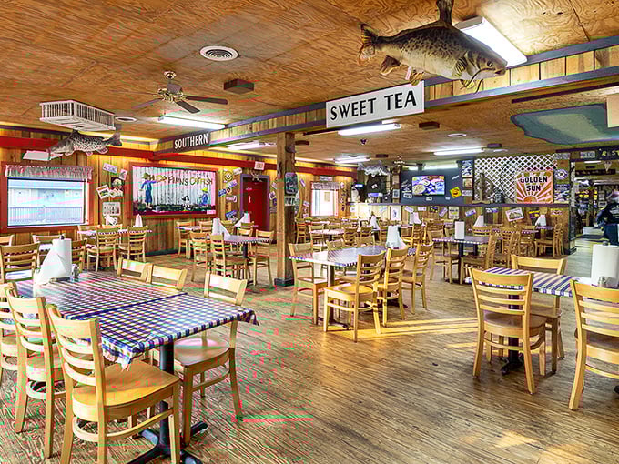 Step inside and you're transported to a fishing cabin fever dream. Wooden tables, mounted fish, and "SWEET TEA" signs announce you've arrived somewhere authentically Southern.